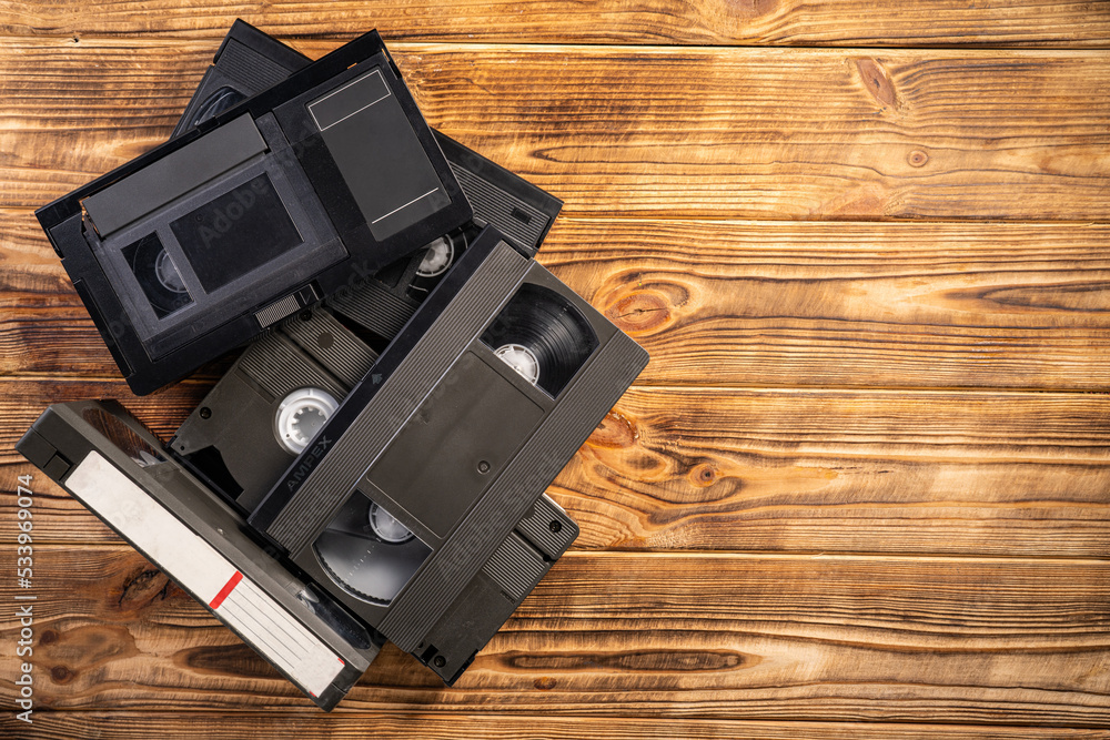 Black old VHS analog videotape cassettes on brown wooden vintage ...