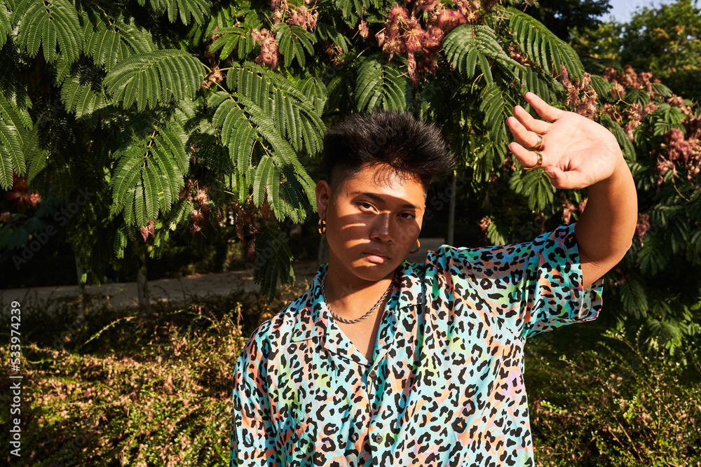Filipino non binary person protecting face from sun Stock Photo | Adobe ...