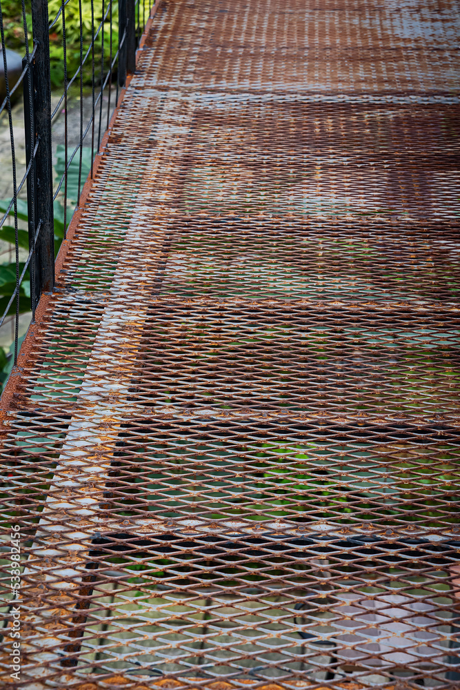 A metal grid background was used to create a high-altitude walking ...