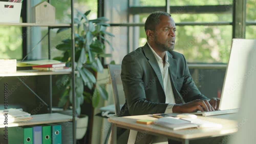 Footage of stressed disappointed man sitting in front of computer and ...