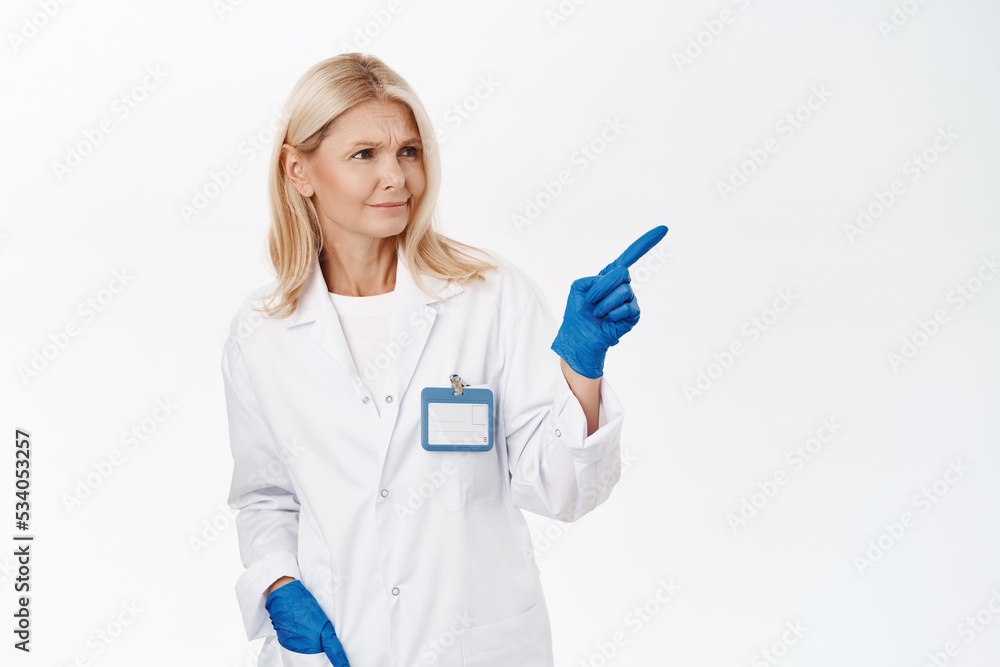 Female lab worker, doctor pointing right at smth strange, looks ...