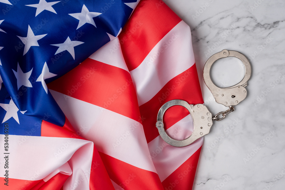 Wallpaper with the flag of the united states next to handcuffs on a ...