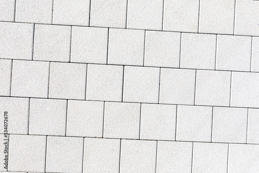 Coating with modern textured paving tiles of square shape. White square ...