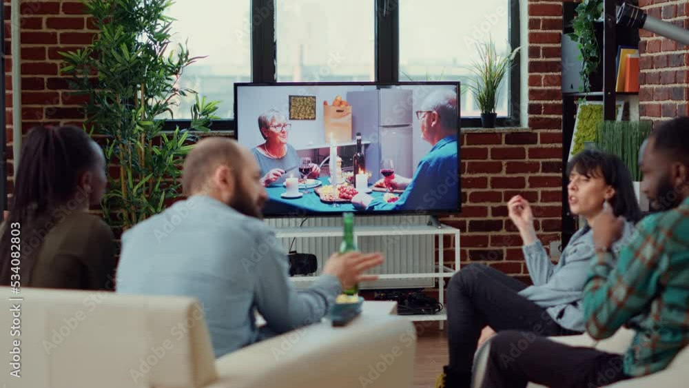 Video Stock Group of friends watching drama action film on television, enjoying cinema movie ...