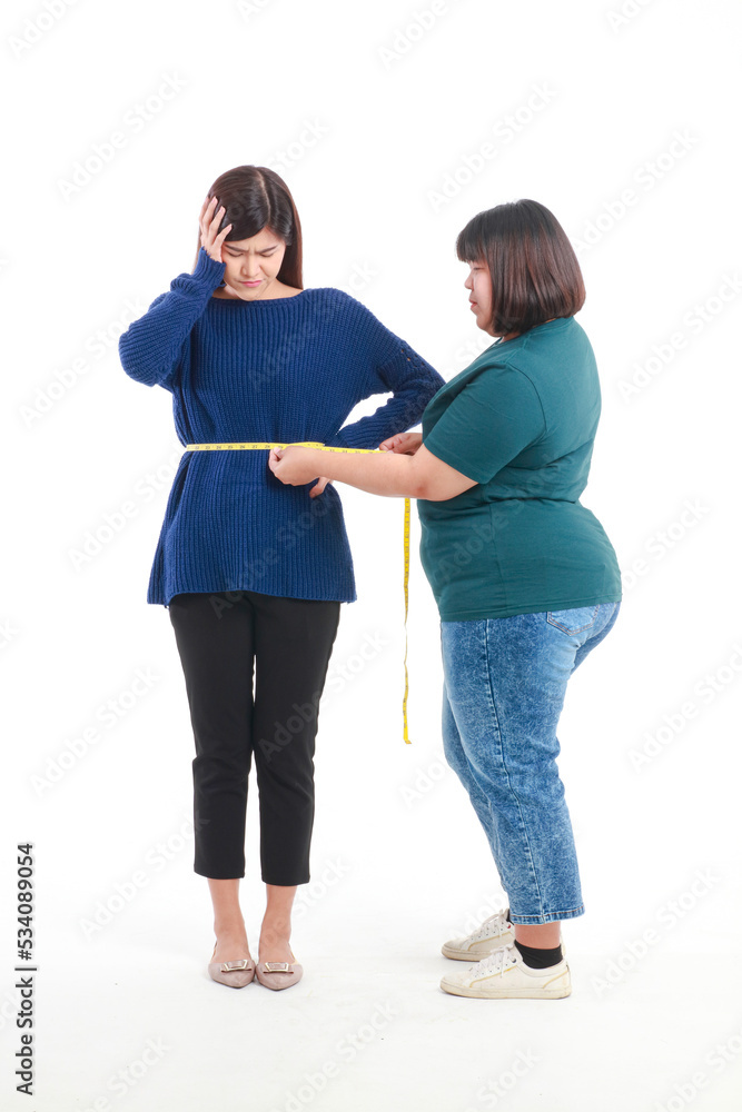 Fat Asian woman holding a tape measure around her waist to measure ...