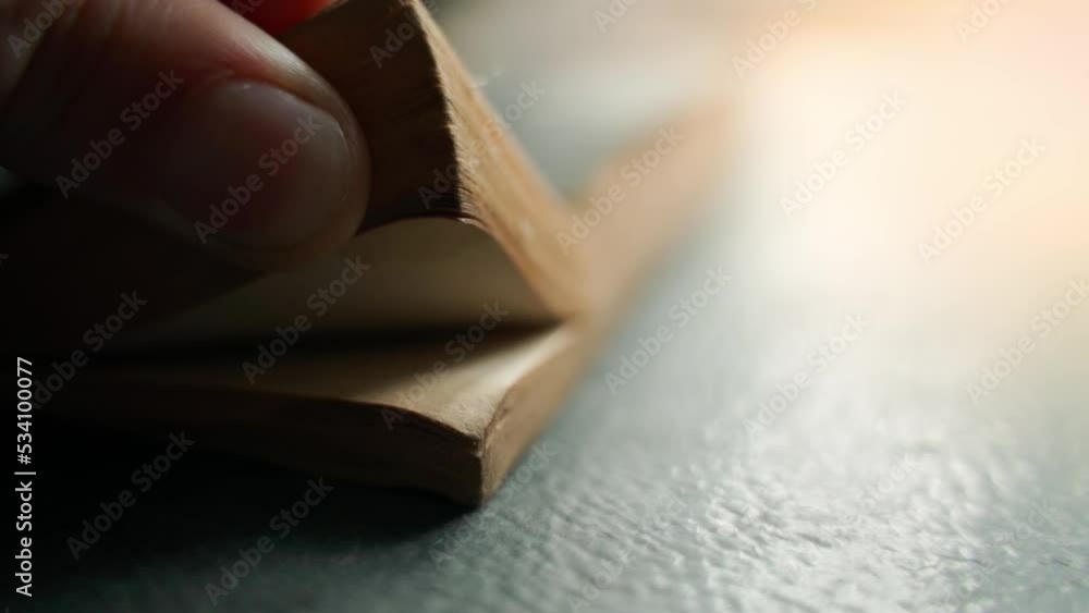 Vidéo Stock Hand sorting through the sheets of an old book close-up ...