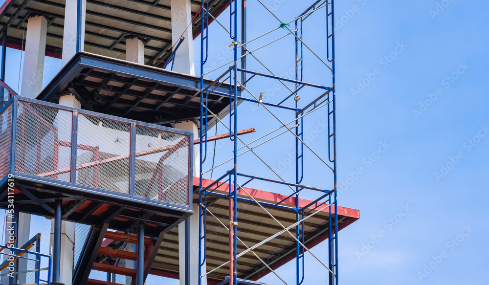 Low angle view of scaffolding with metal staircase structure outside of ...