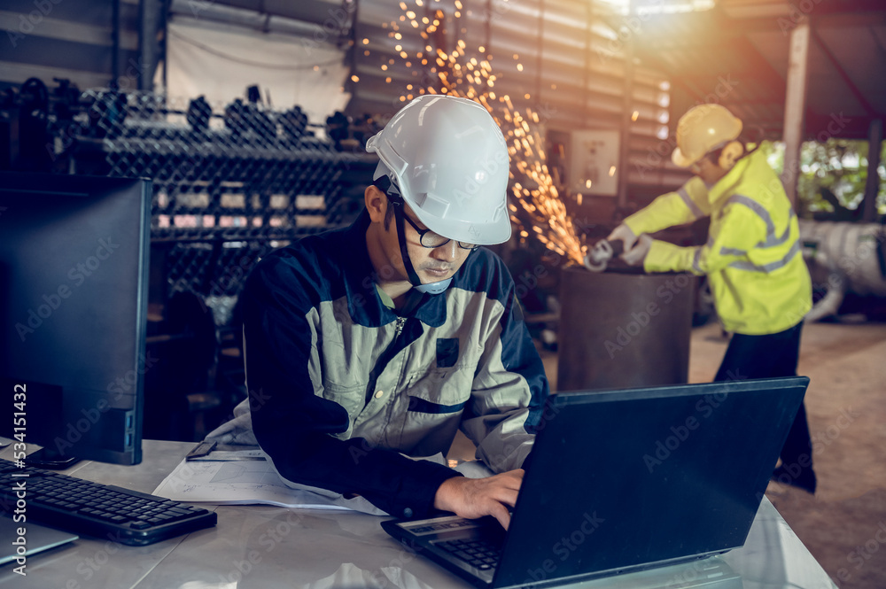 Asian project engineers who control production line facilities Use ...