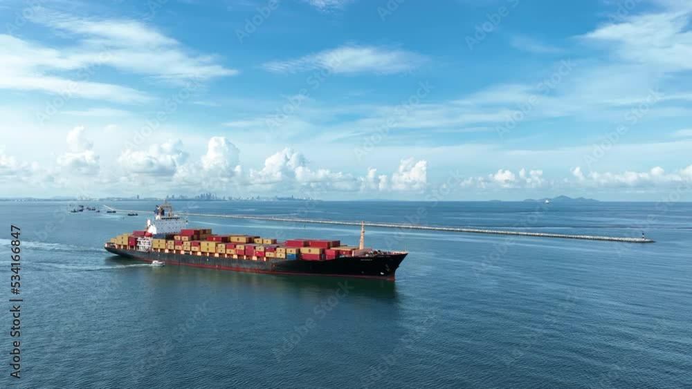 Video „Aerial side view of cargo ship carrying container and running ...