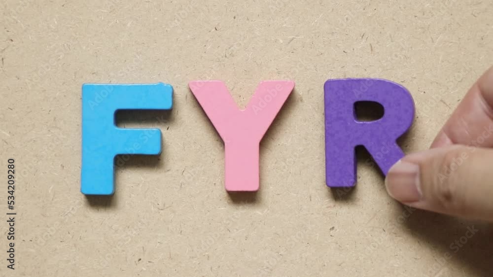 Man hold wood letter to complete english word FYR (abbreviation of for ...