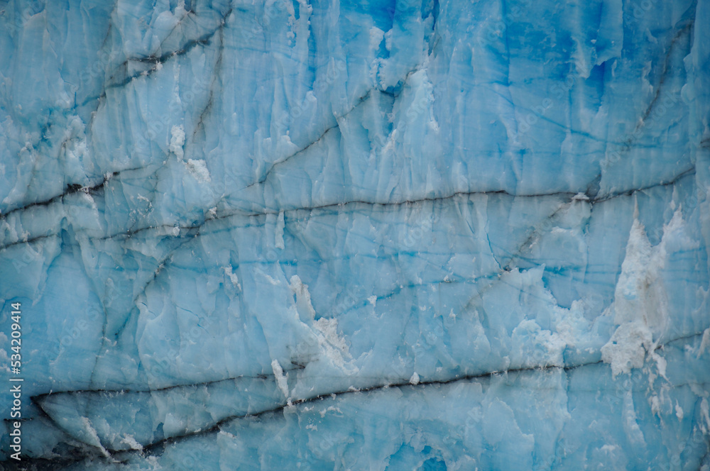 texture and background of glacier ice walls crossed by black lines of ...