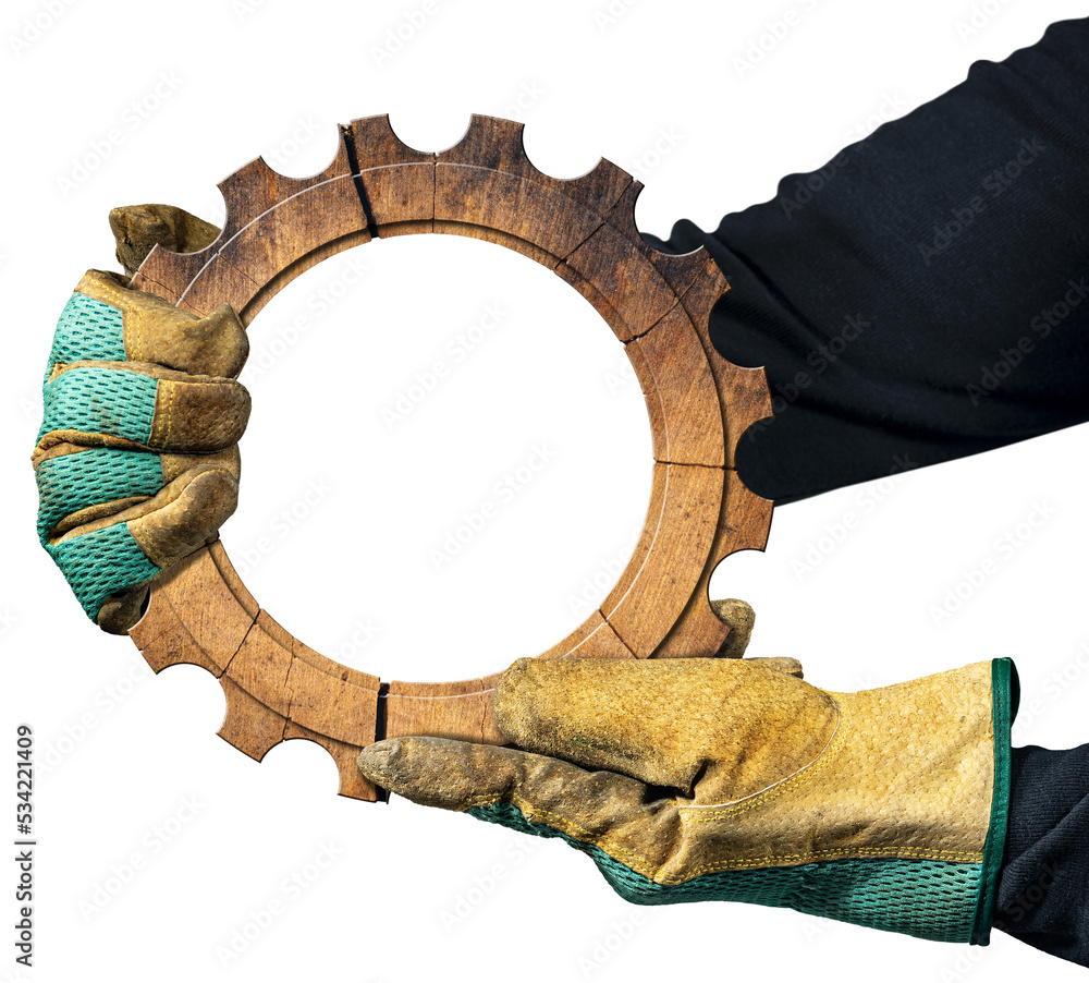 Manual worker with work gloves holding a wooden cogwheel with copy ...