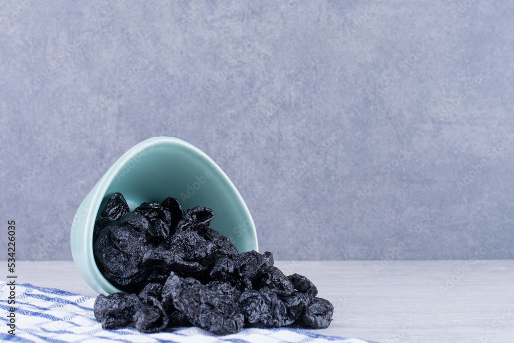 Dried black sultana in a bowl on concrete background Stock Photo ...