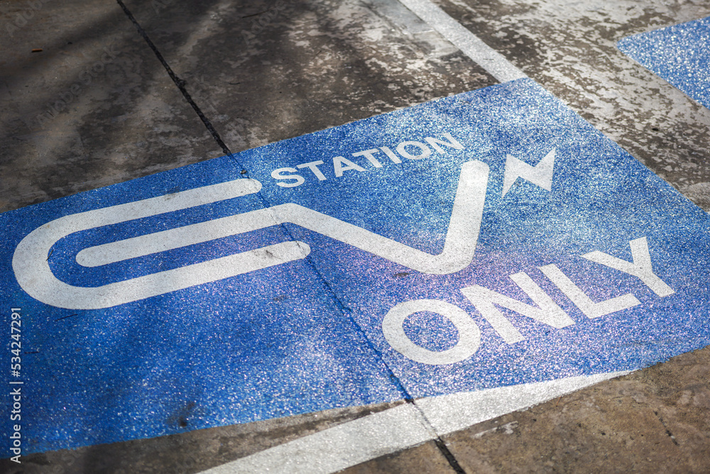 EV station sign on cement ground, reservation for electric car parking ...