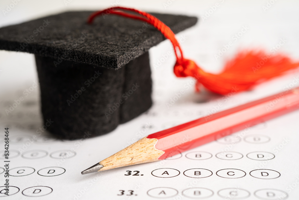 Graduation hat and pencil on Answer sheet background, Education study ...