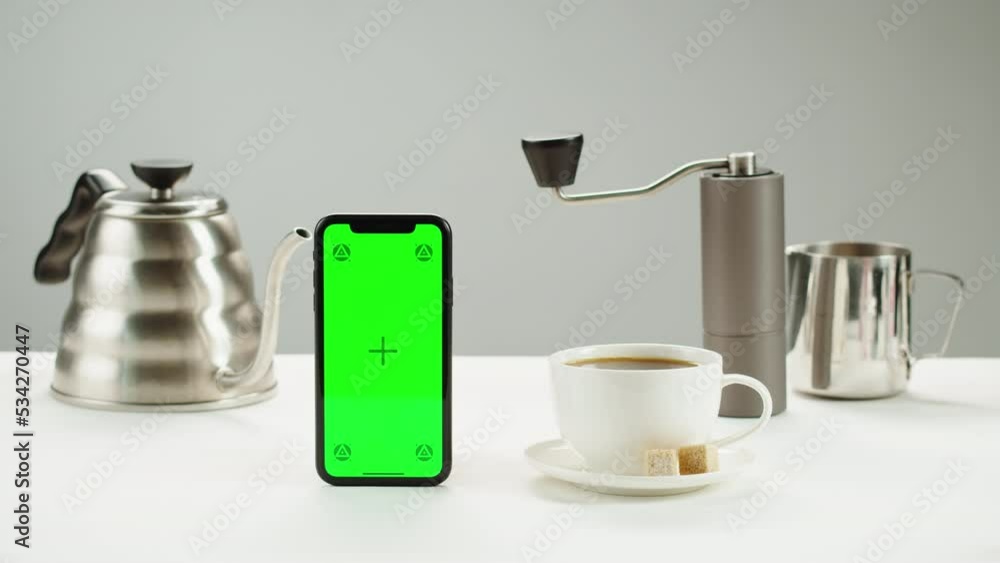 Mobile phone with green screen chroma key screen with cafe coffee shop ...