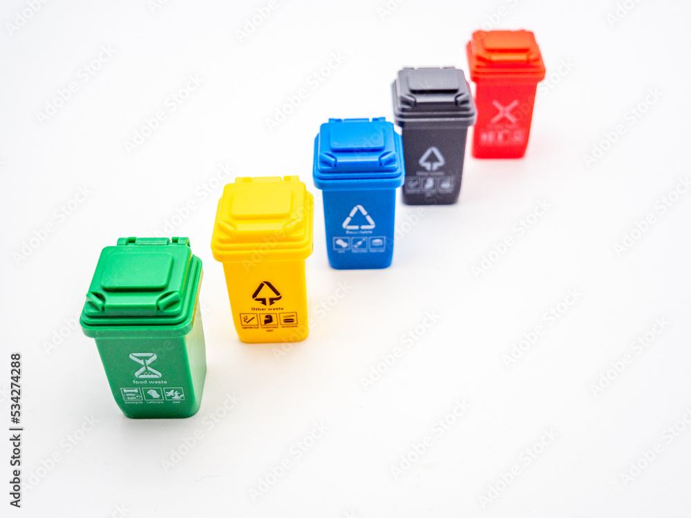 various colored recycle bins for different type of trash on white ...
