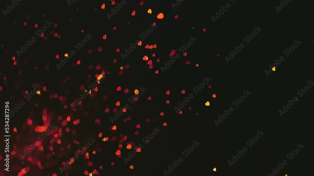 red fire sparks are scattering, fire background, spark and flare effect ...