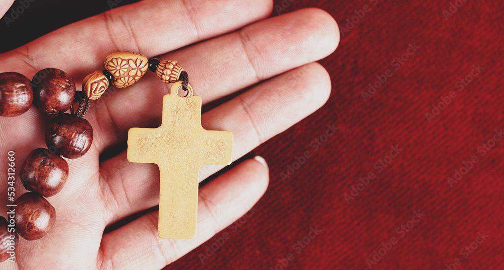 The crucifix is in the hands of a man who is praying for the blessing ...