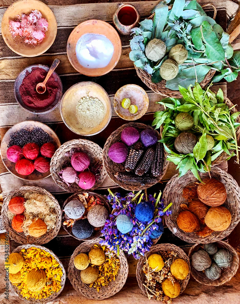 Set of natural sources of colours in ceramic bowls and threads painted ...