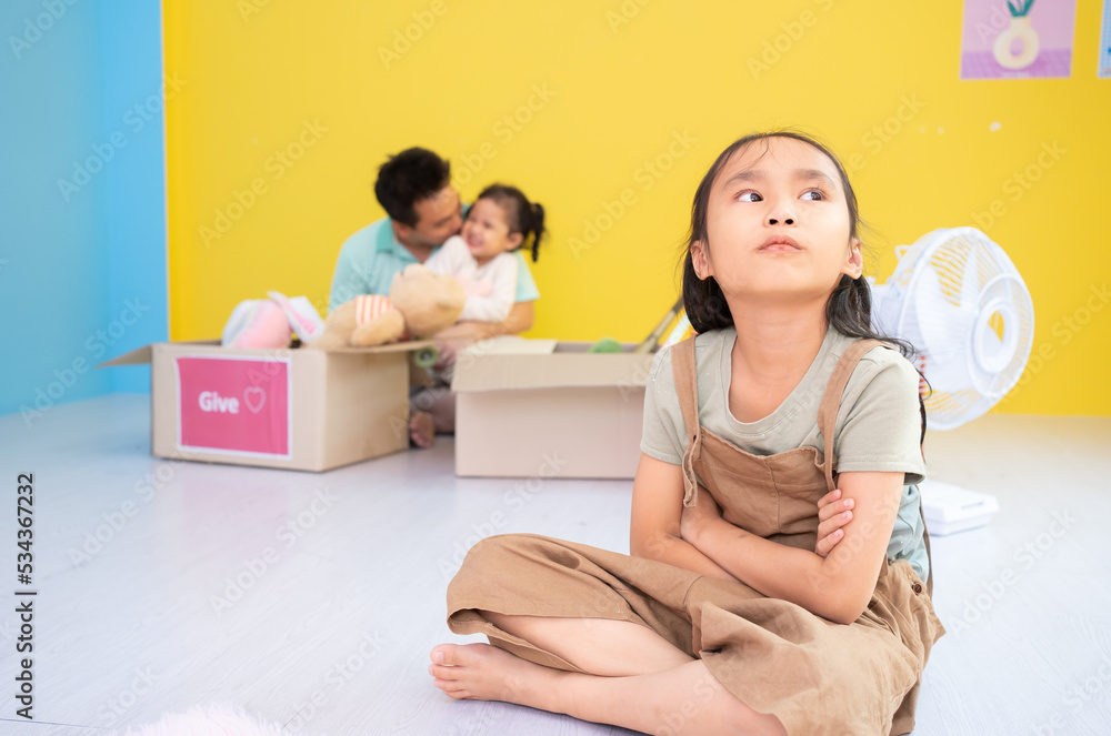 Asian Unhappy little girl feeling jealous while father spending time ...