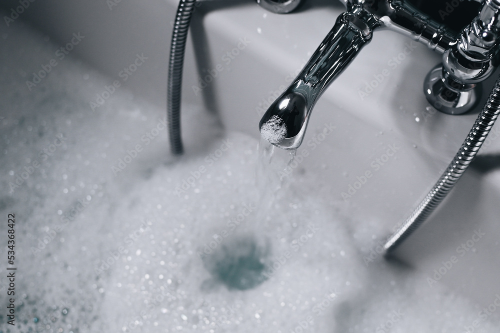 Hot bath. Warm water is drawn into the bath. The concept of bath time ...