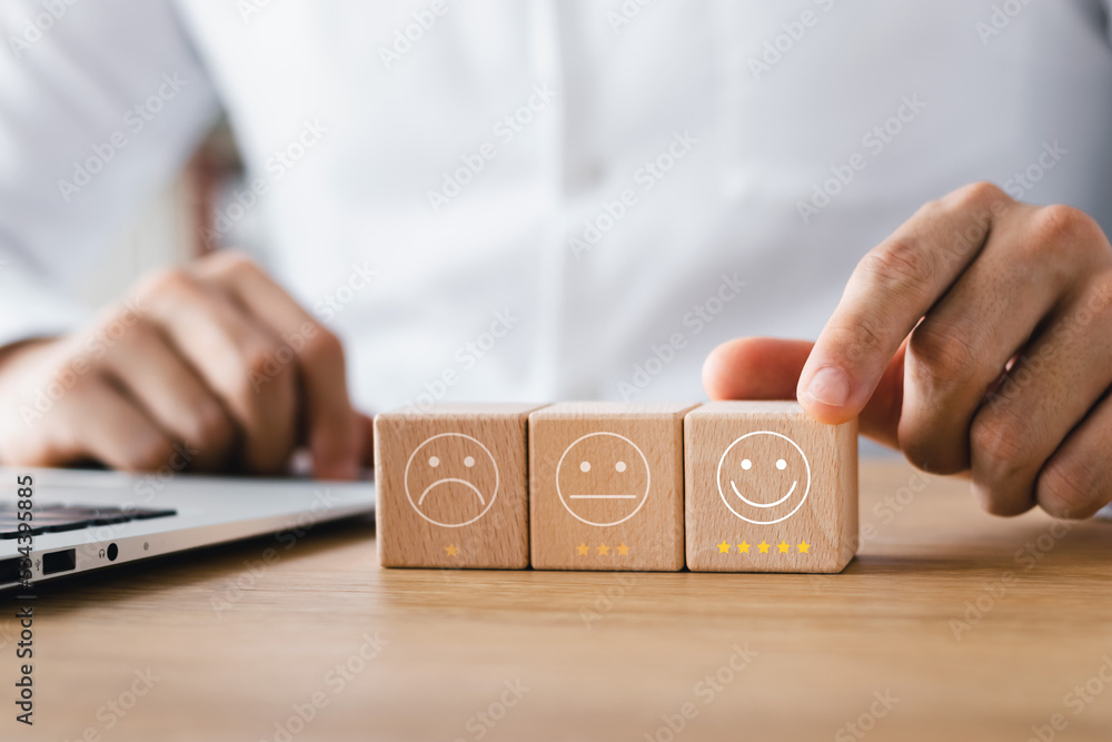Customer satisfaction survey concept, customer hand selects wooden cube ...