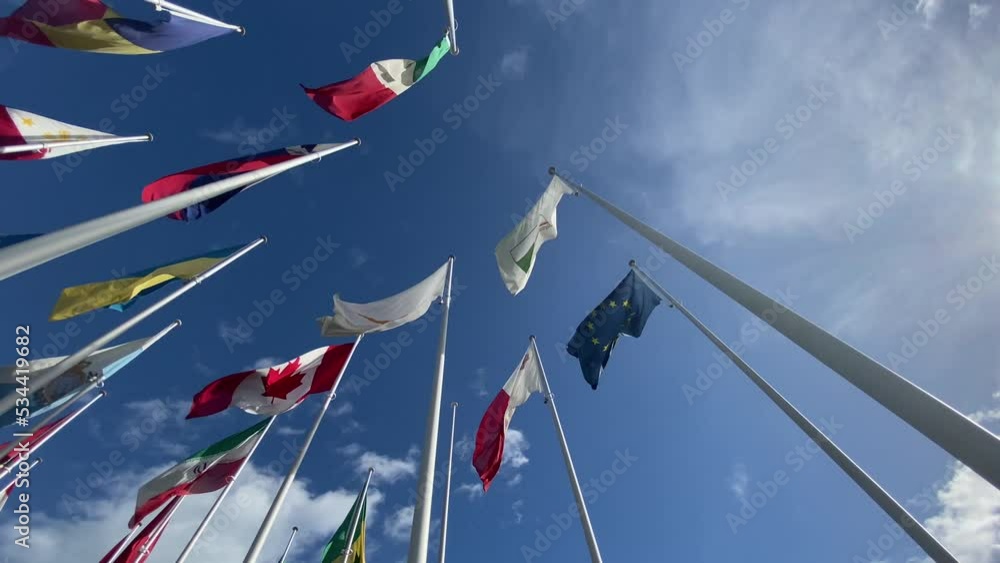 Flags of the World waving in the wind on a background blue sky and ...
