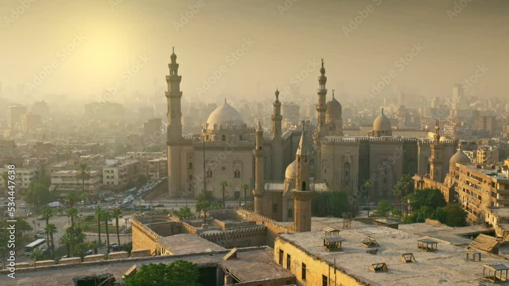 Cairo city in light fog in the rays of setting sun. Zoom out of Mosque ...