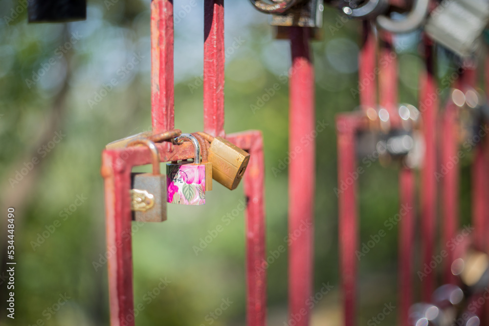 Locks of Love. The locks hang on the pedestrian bridge in the park and ...