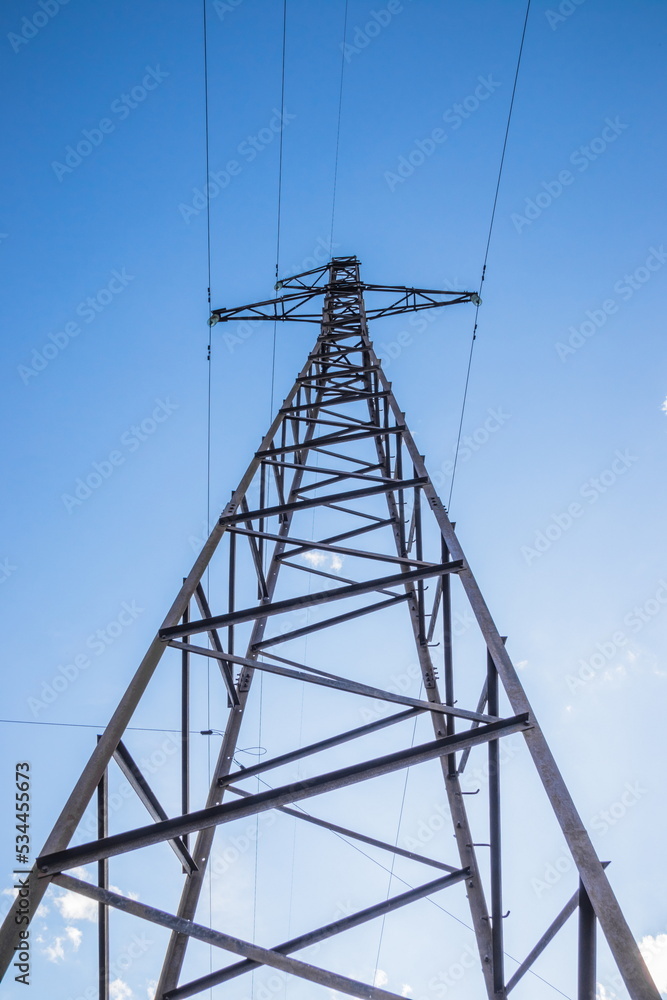 High voltage, power transmission line on the mountain range on a blue ...