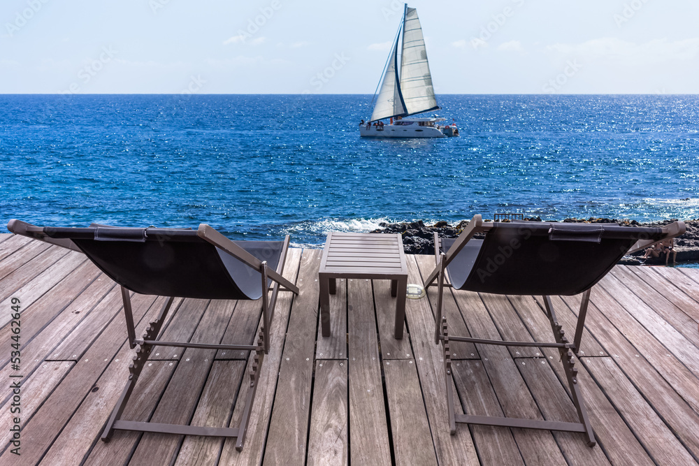 Terrasse avec vue sur voilier en mer Stock Photo | Adobe Stock