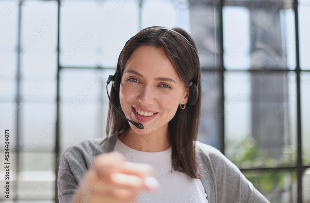 Foto de call center operator woman pointing with finger to the camera ...