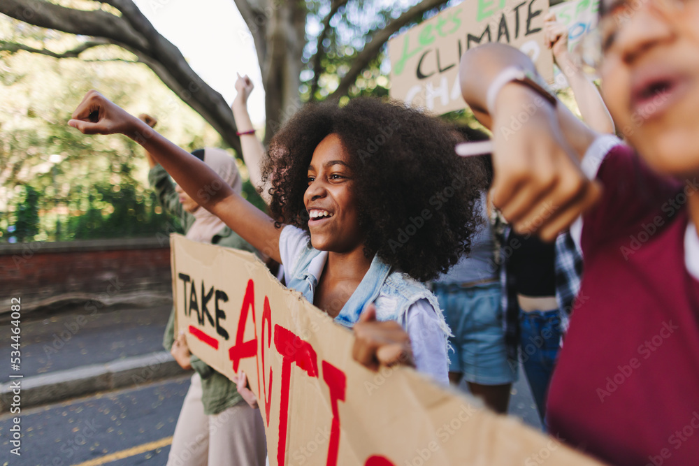 Cheerful young people standing up against climate change Stock Photo ...