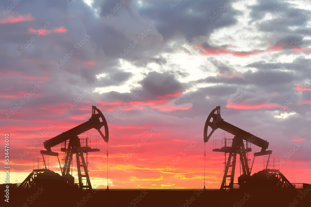 Oil drilling derricks at desert oilfield. Crude oil production from the ...