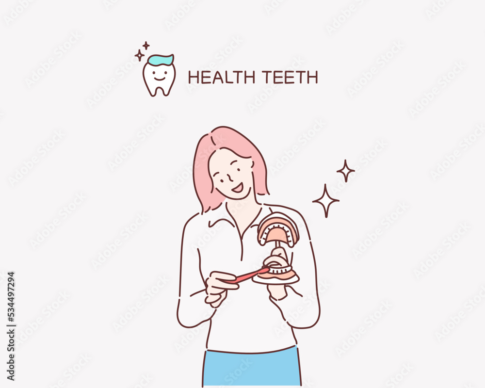 Dentist showing on a jaw model how to clean the teeth with tooth brush ...