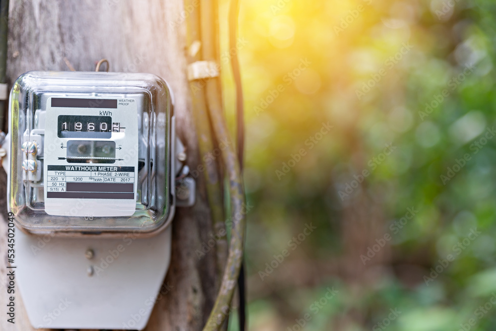Kilowatt hour meter on blur sky background. Electric power meter ...