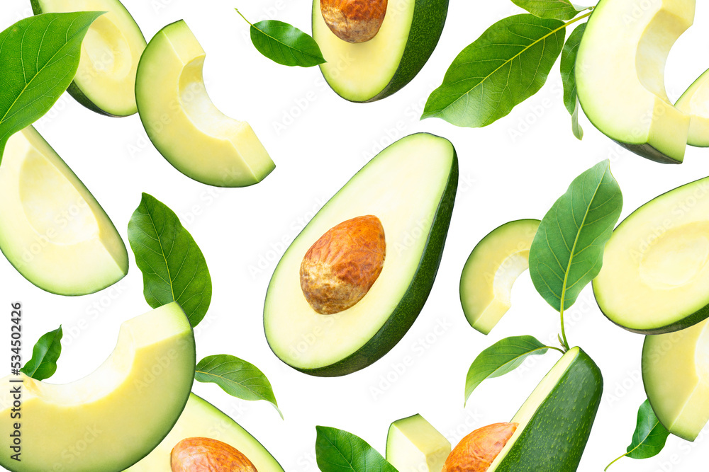 Falling and flying fresh avocado and green leaves with pit isolated on ...