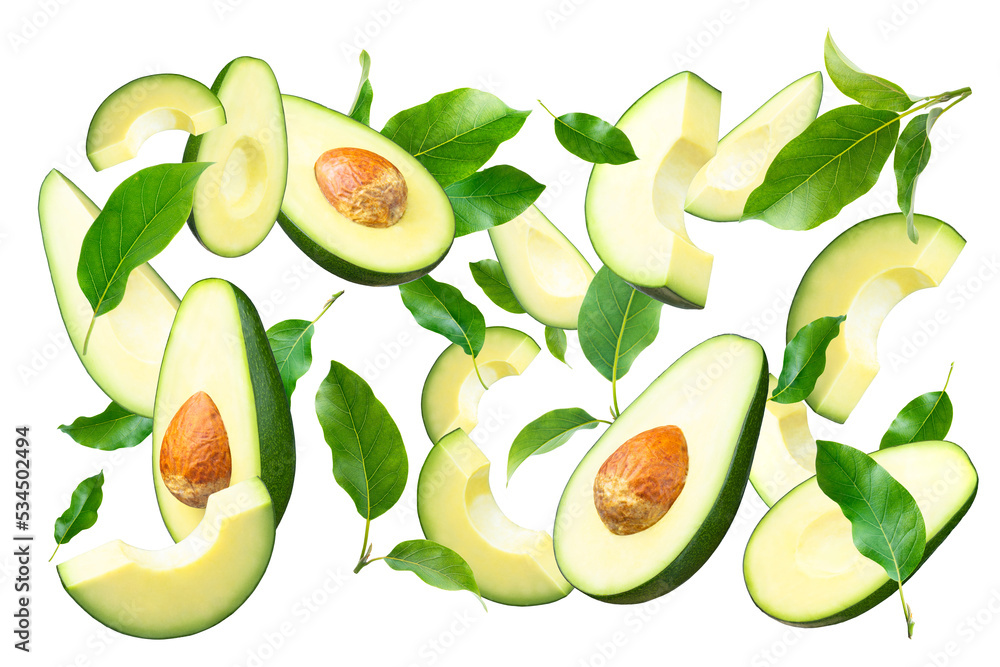 Falling and flying fresh avocado and green leaves with pit isolated on ...