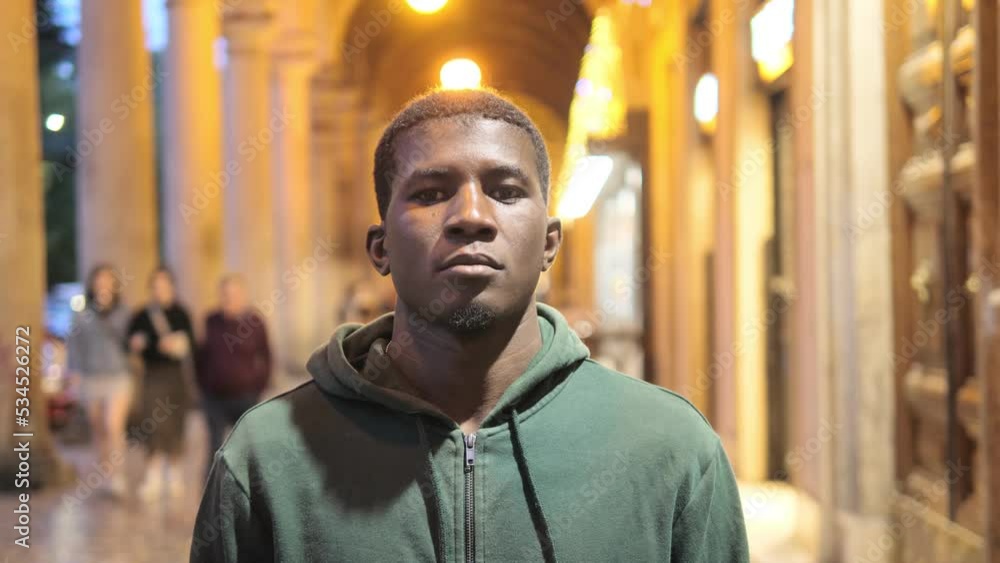 Serious young black man staring at camera in the night Stock ビデオ ...