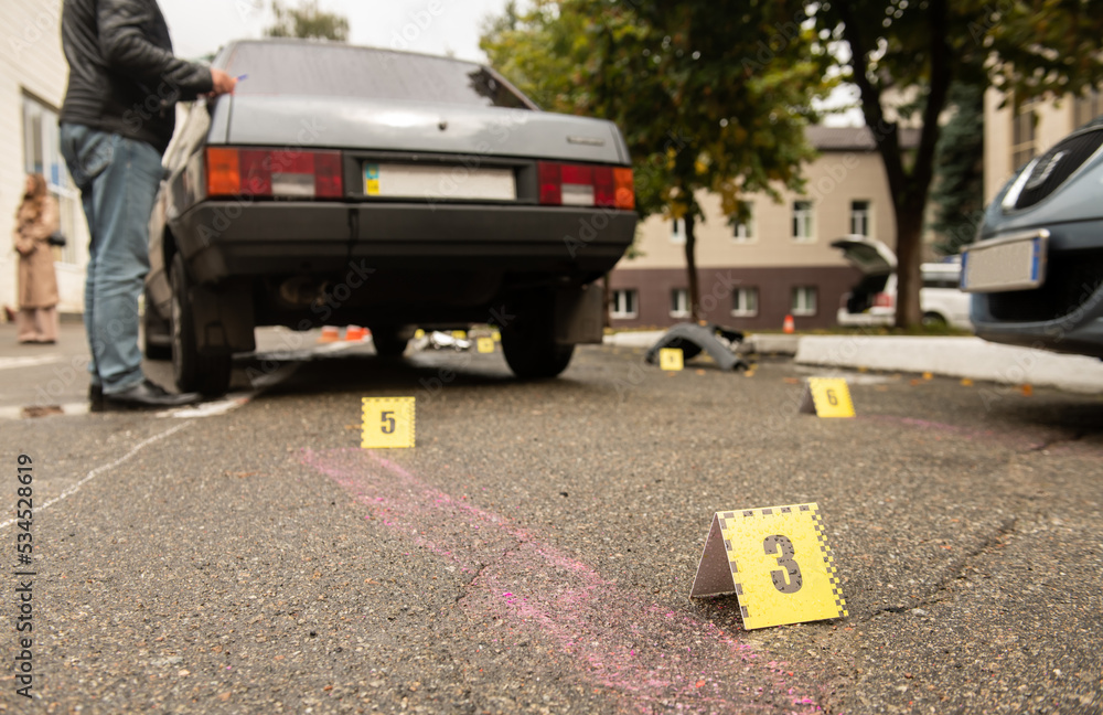 Scene of a traffic accident with car wreckage and police numbers ...
