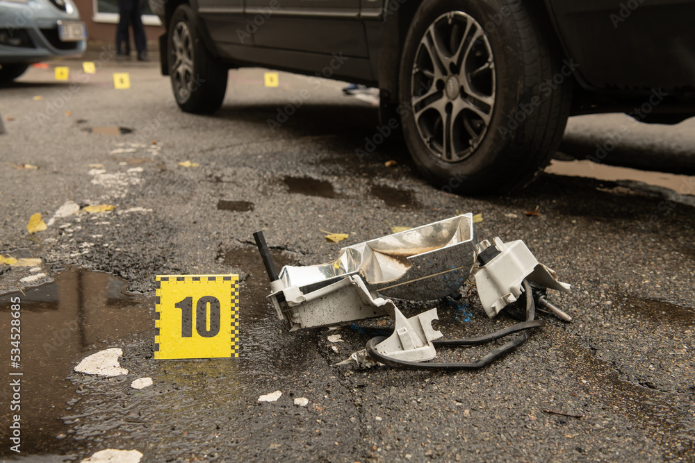 Scene of a traffic accident with car wreckage and police numbers ...
