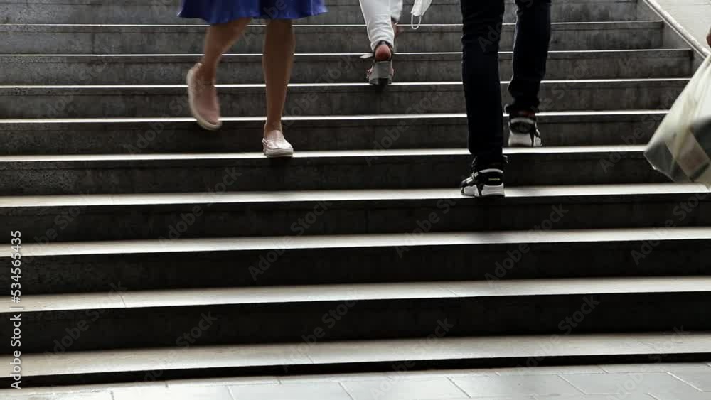 Closeup isolated legs of pedestrians descending the steps in the subway ...