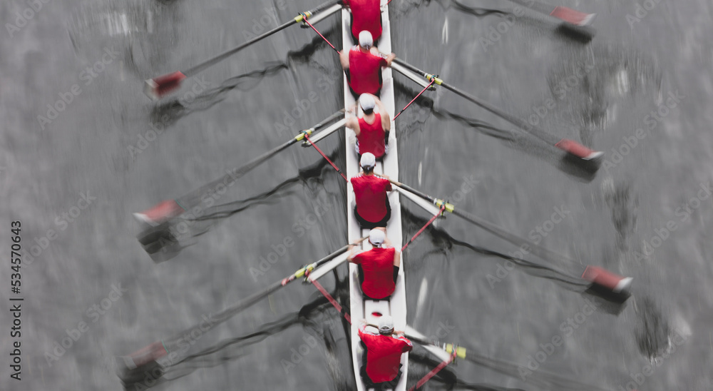 Overhead view of a crew rowing in an octuple racing shell boat, rowers ...