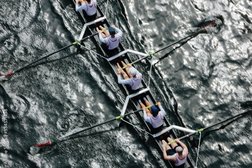 Overhead view of female crew racers rowing in an octuple racing shell ...