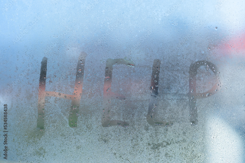 words help handwritten on night wet window glass with green and blue ...
