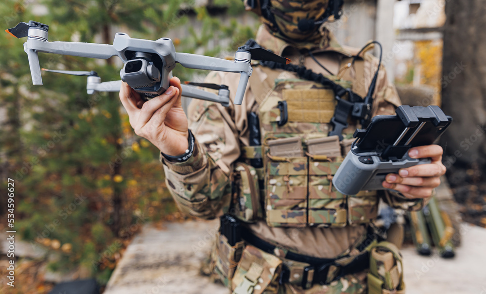 Modern army soldiers using aerial drone for artillery guidance and ...