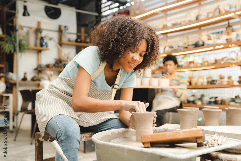 Beautiful young woman holding pottery instrument for scraping ...
