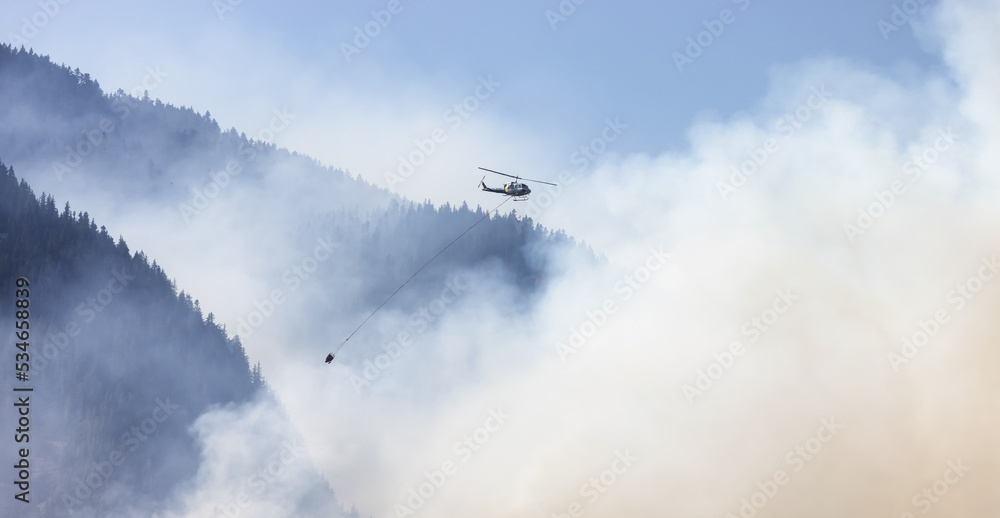Wildfire Service Helicopter flying over BC Forest Fire and Smoke on the ...