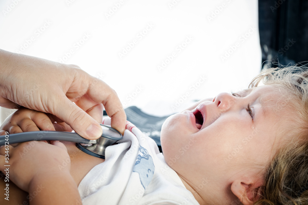 Pediatric doctor listening to a crying baby with a stethoscope Stock ...